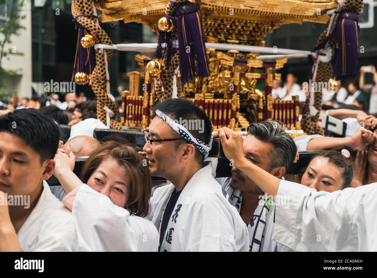 Crowds of japanese people carrying Shinto Shrine Mikoshi around the ...