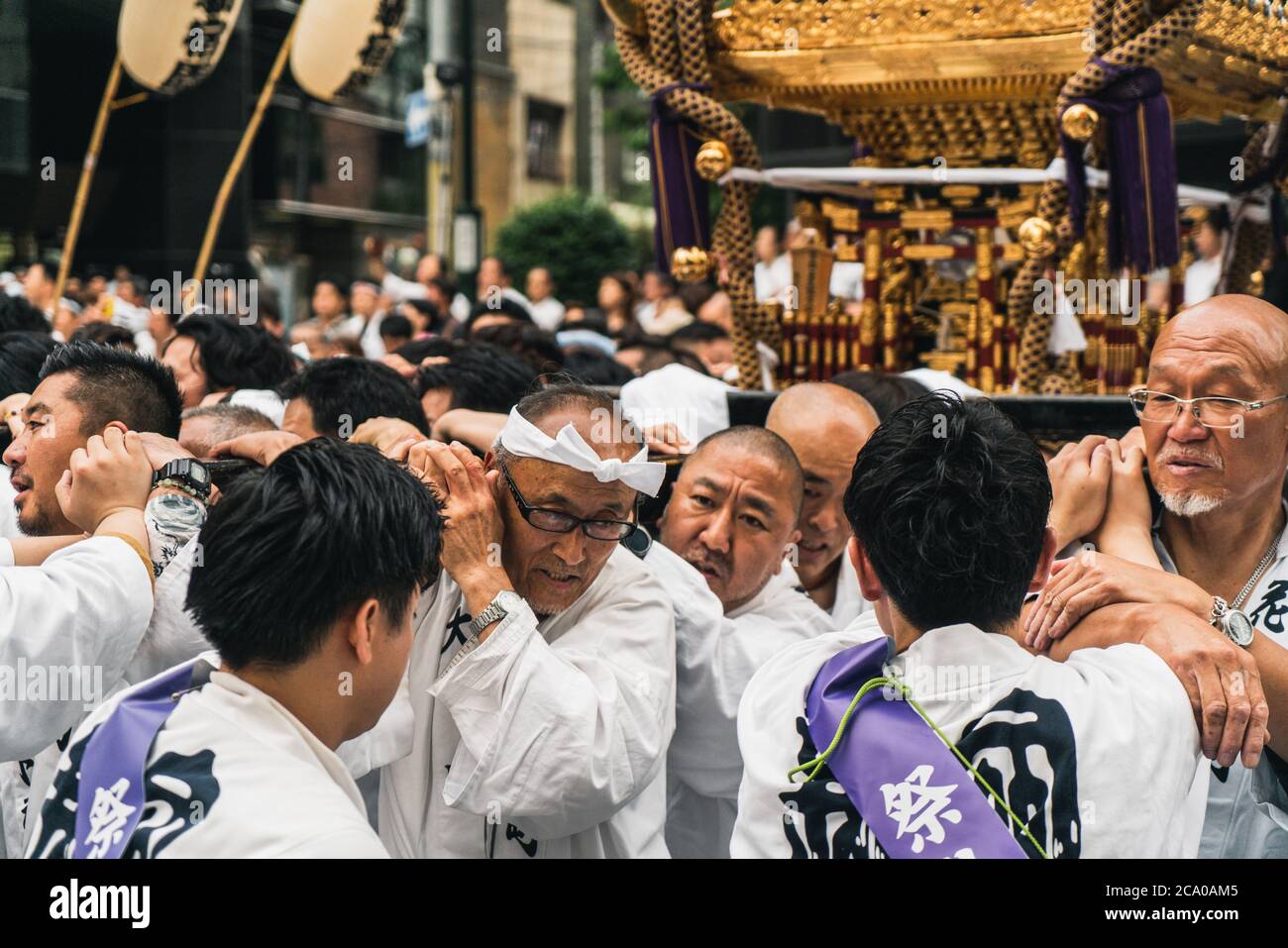 Crowds of japanese people carrying Shinto Shrine Mikoshi around the ...