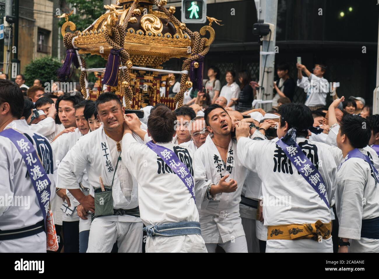 Crowds of japanese people carrying Shinto Shrine Mikoshi around the ...