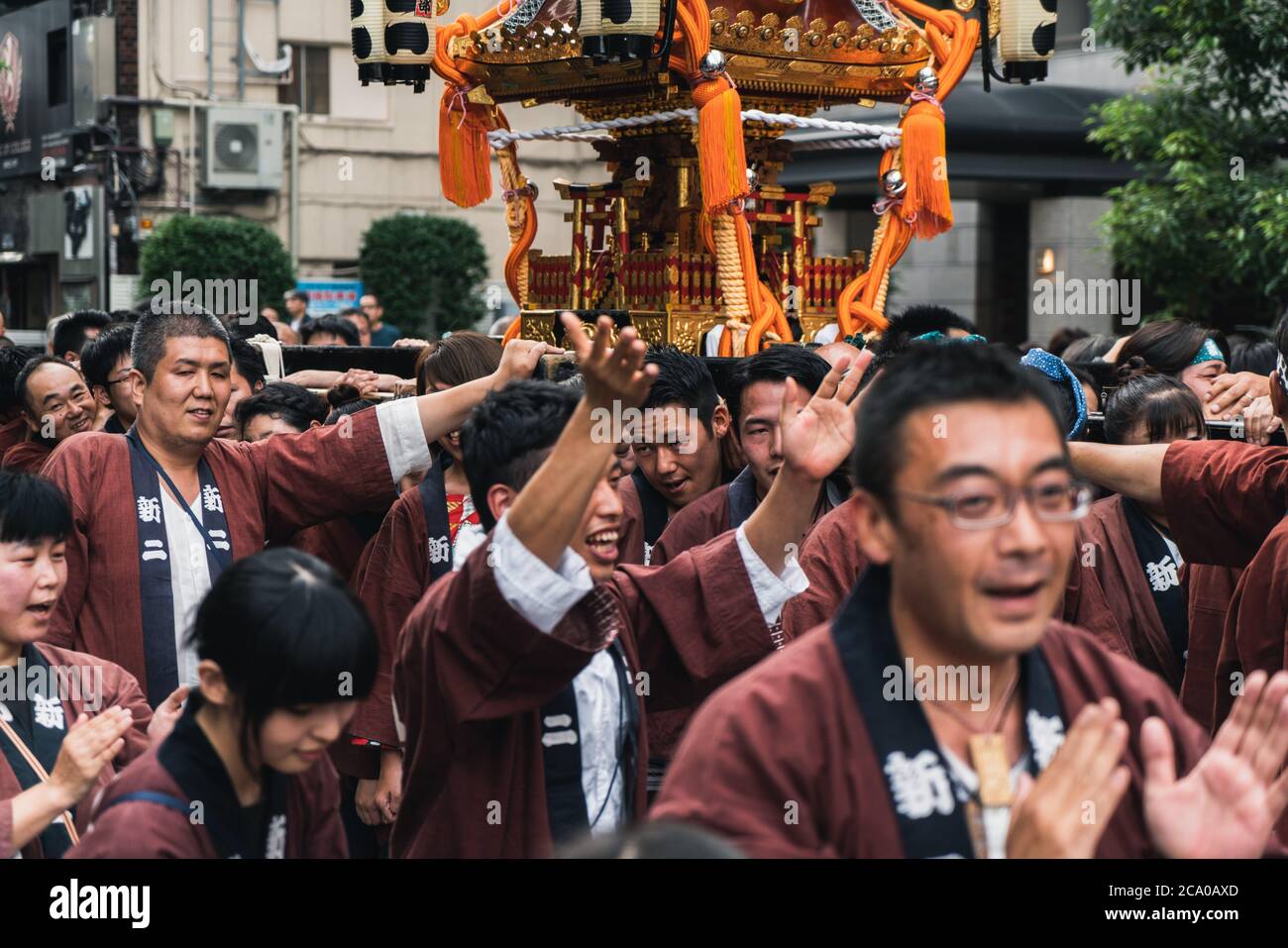 Crowds of japanese people carrying Shinto Shrine Mikoshi around the ...
