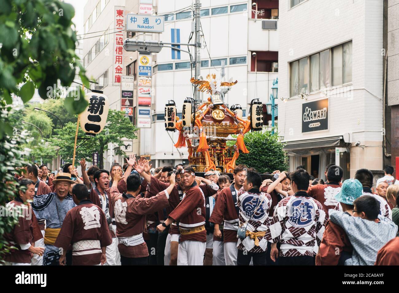 Crowds of japanese people carrying Shinto Shrine Mikoshi around the ...