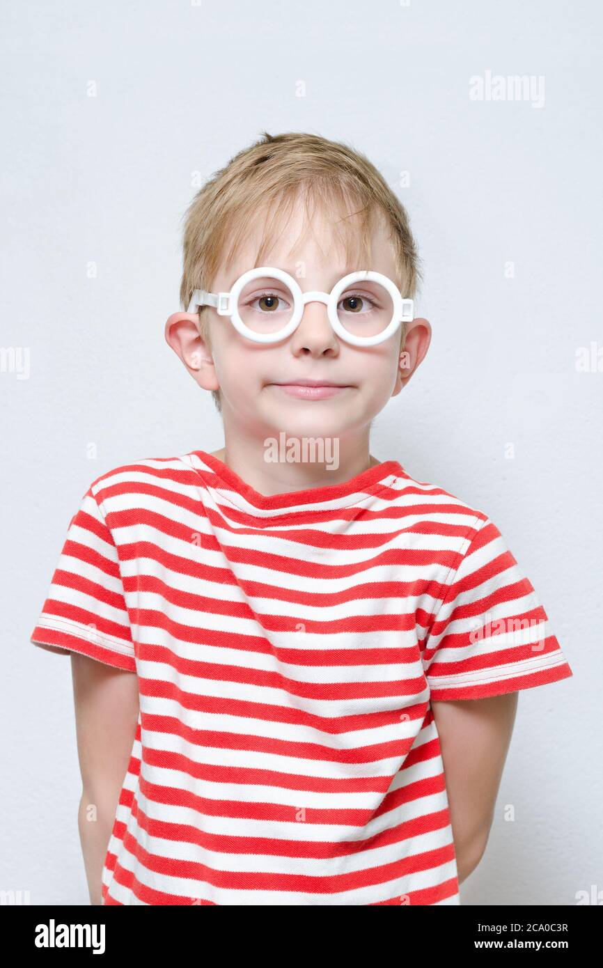 Boy in a striped T-shirt and glasses. Intelligent face Stock Photo - Alamy