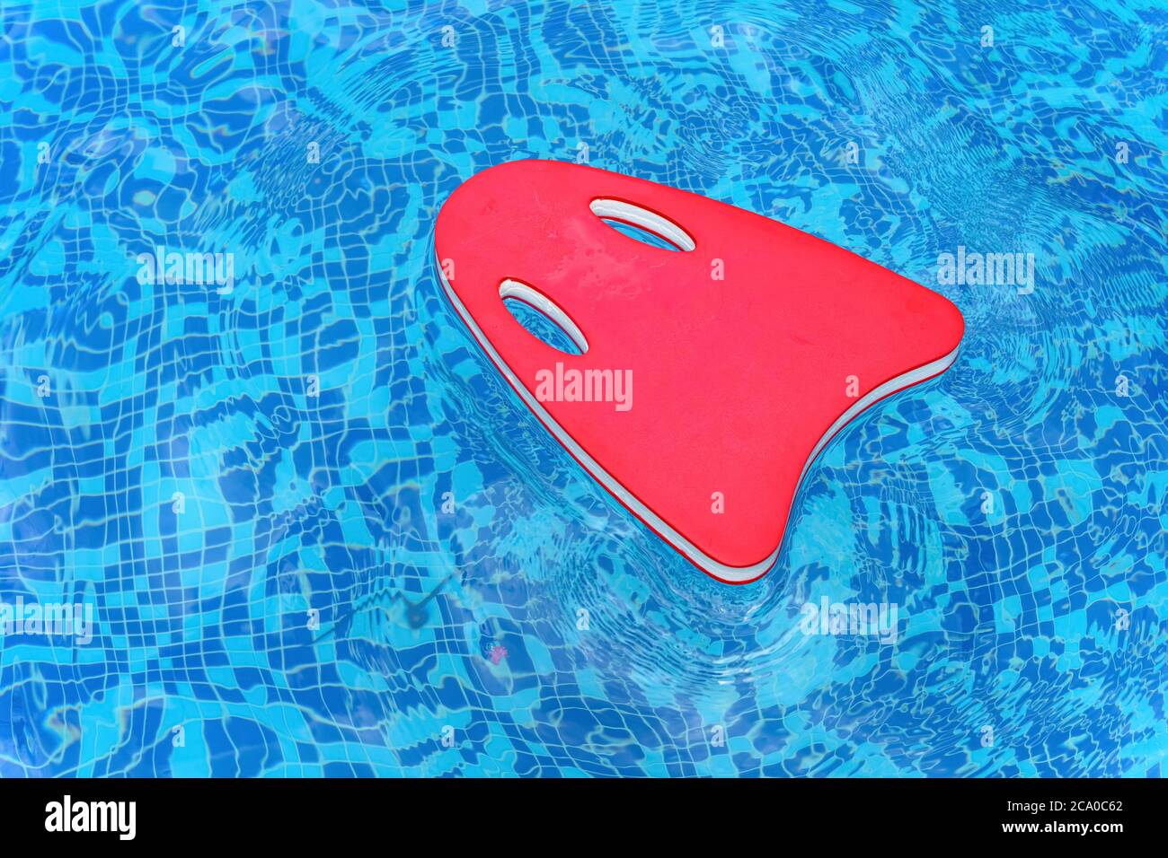red floating pad on a swimming pool Stock Photo - Alamy