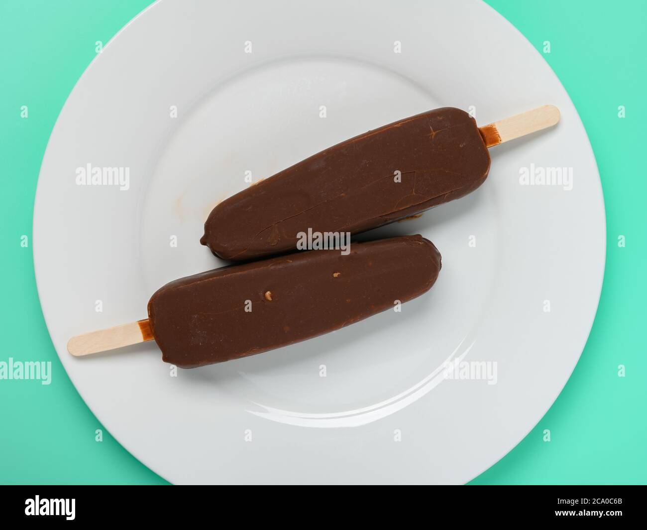 top view two chocolate flavor popsicles on a dish Stock Photo - Alamy