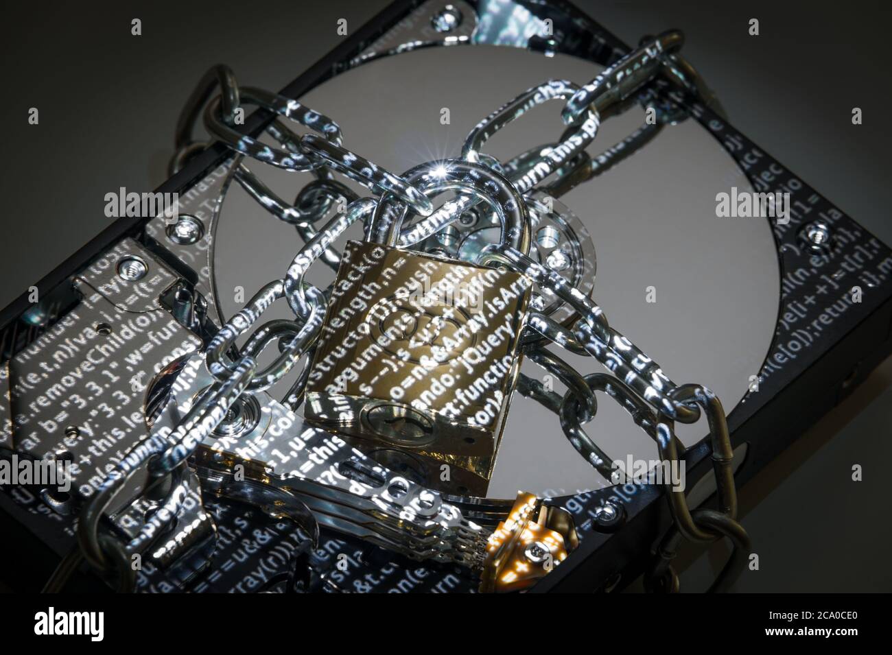 A hard disk drive (HDD) in padlocked chains with data projected on it ...