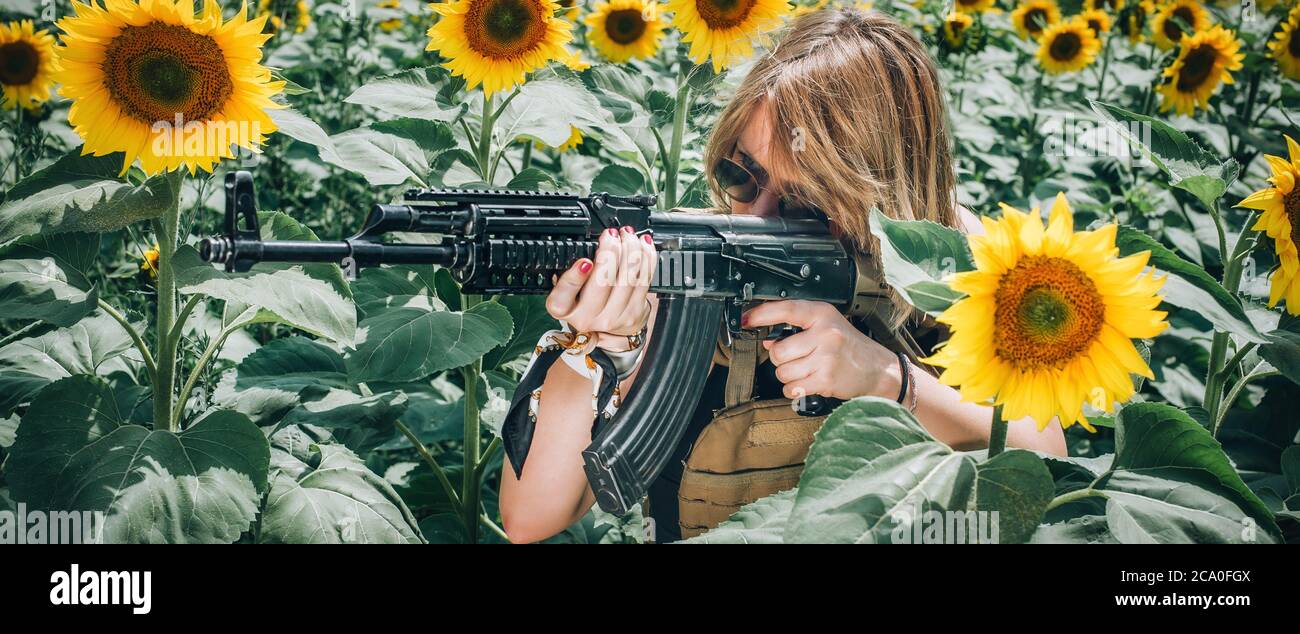 Beautiful and attractive woman soldier with rifle machine gun. Front ...