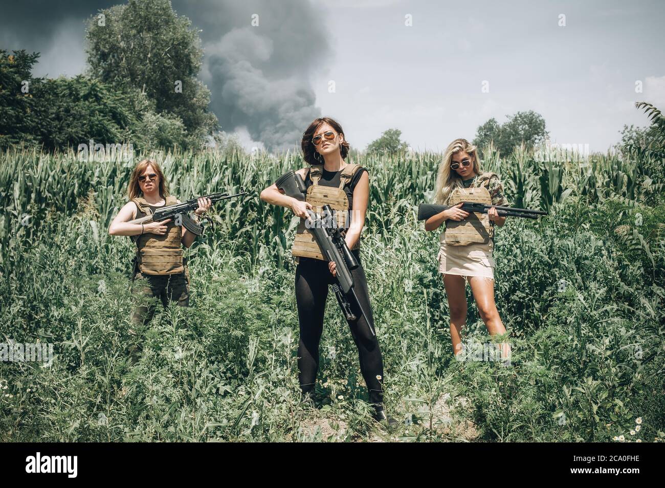 Combat team squad of attractive female military soldier on war zone ...