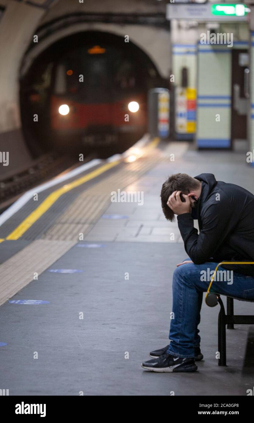 Man sat on train with head in hands hi-res stock photography and images ...