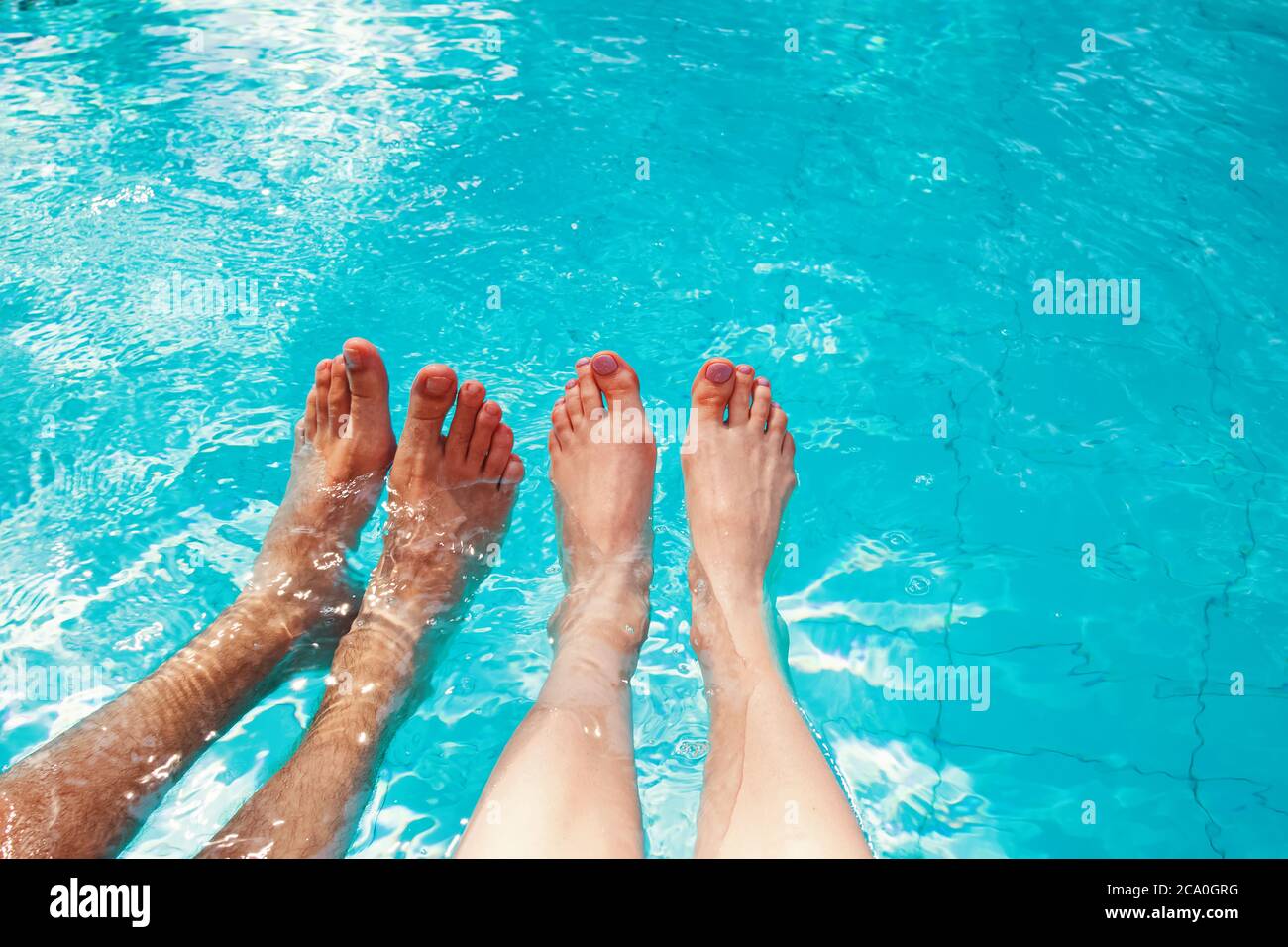 Male and femle feet in swimming pool. R Stock Photo - Alamy
