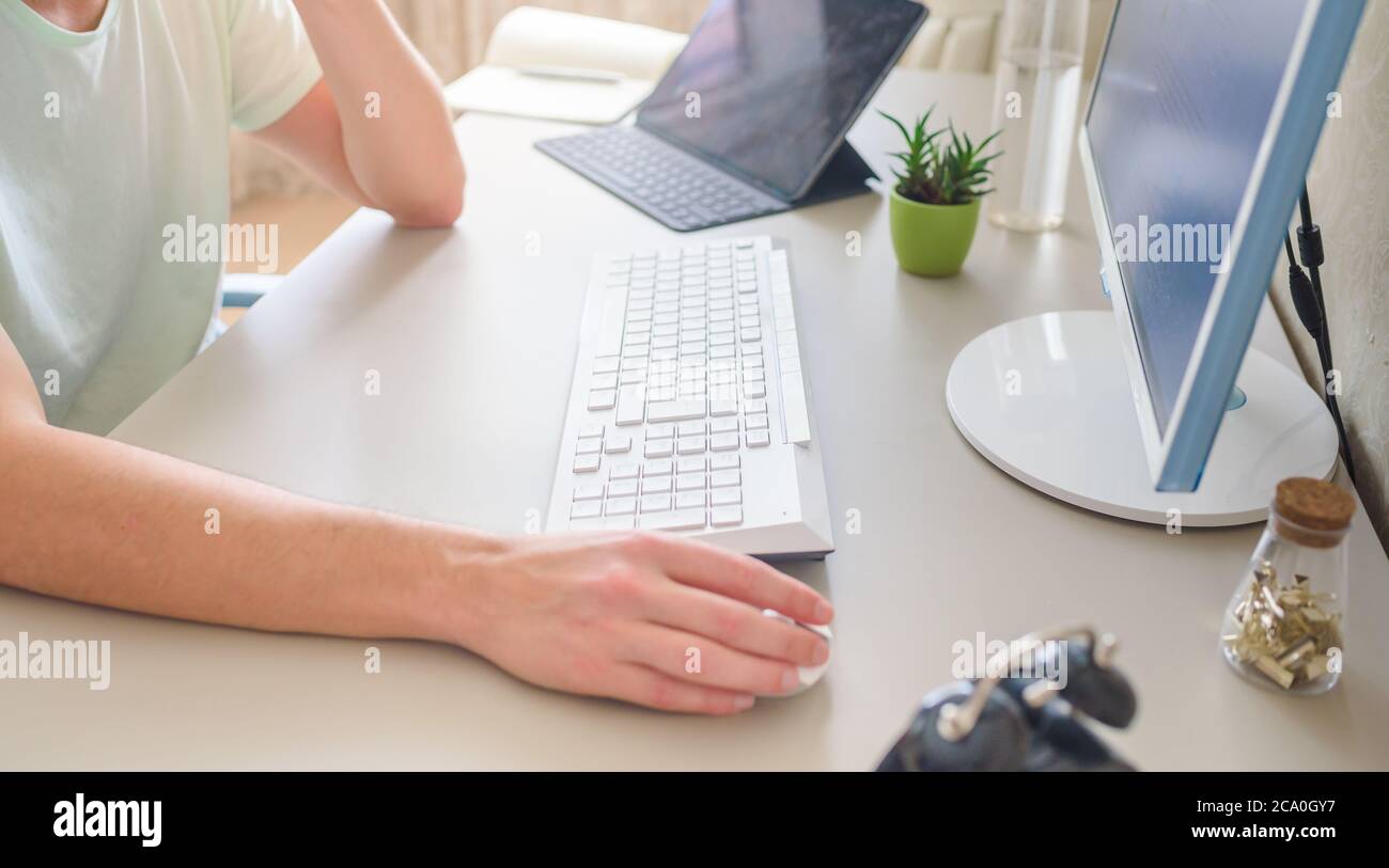 the developer works at the computer, typing, uses the mouse. Selective ...