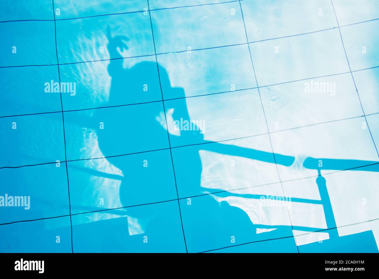 Woman taking photo of her shadow in swimming pool Stock Photo - Alamy