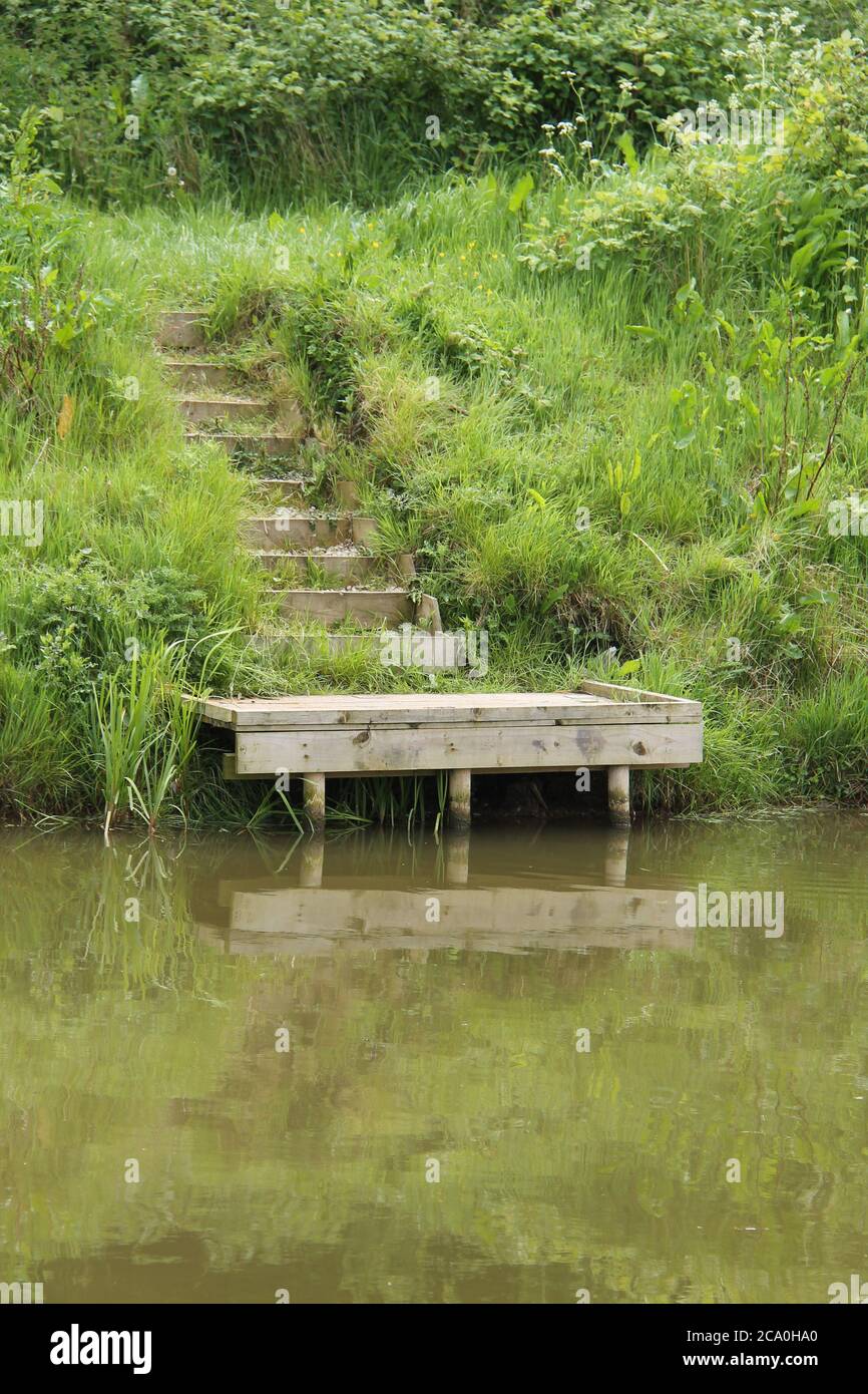 Steps to a Canal Side Wooden Platform for Angling Stock Photo - Alamy