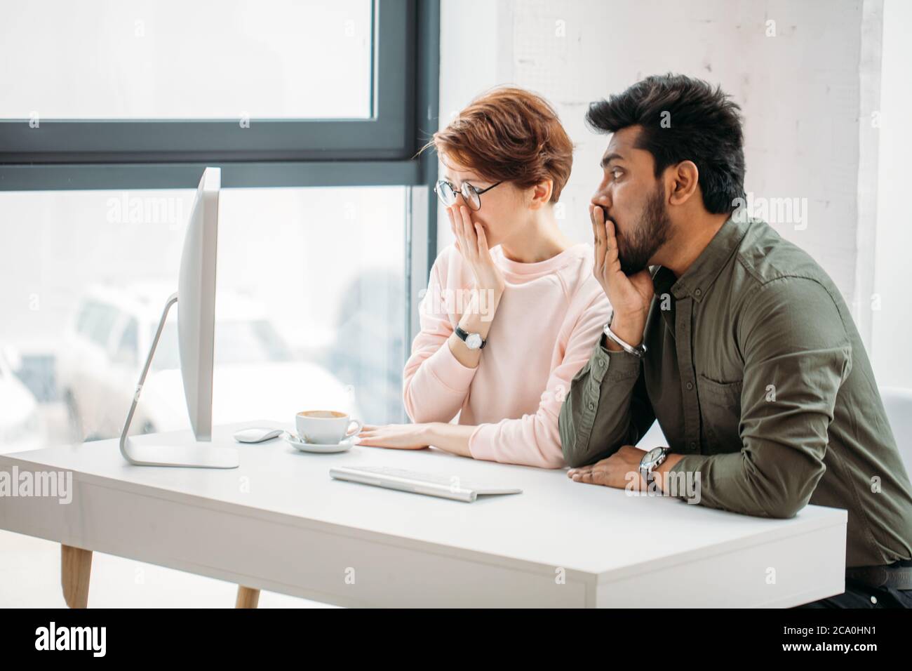 Surprised office people looking at computer screen with amazement ...