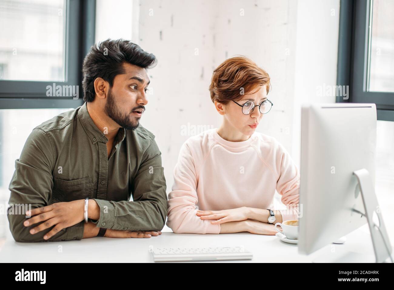 Surprised office people looking at computer screen with amazement ...
