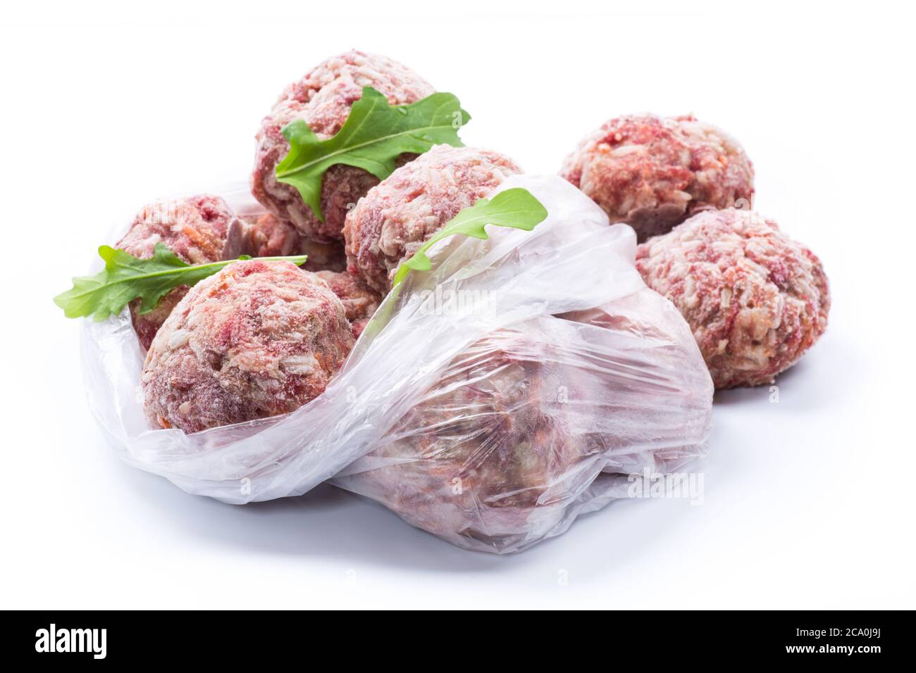frozen raw meatballs from beef and pork with carrots and rice isolated ...
