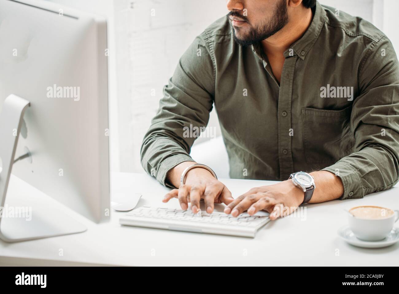 young indian man working at computer from modern bright office Stock ...