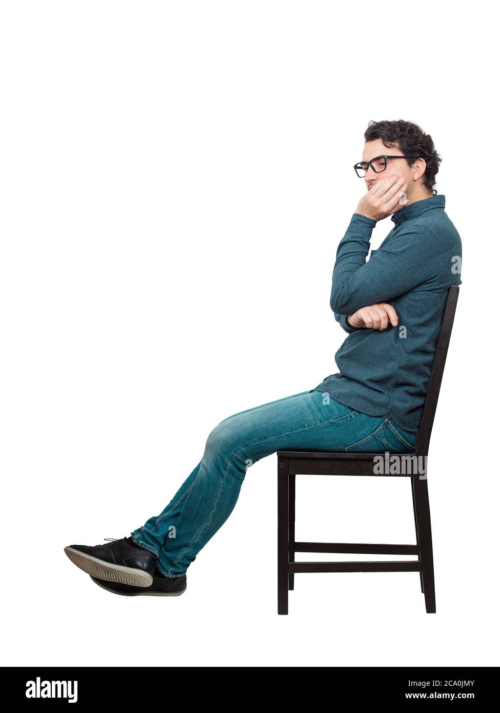 Side view full length annoyed businessman sitting on chair, keeps hand ...