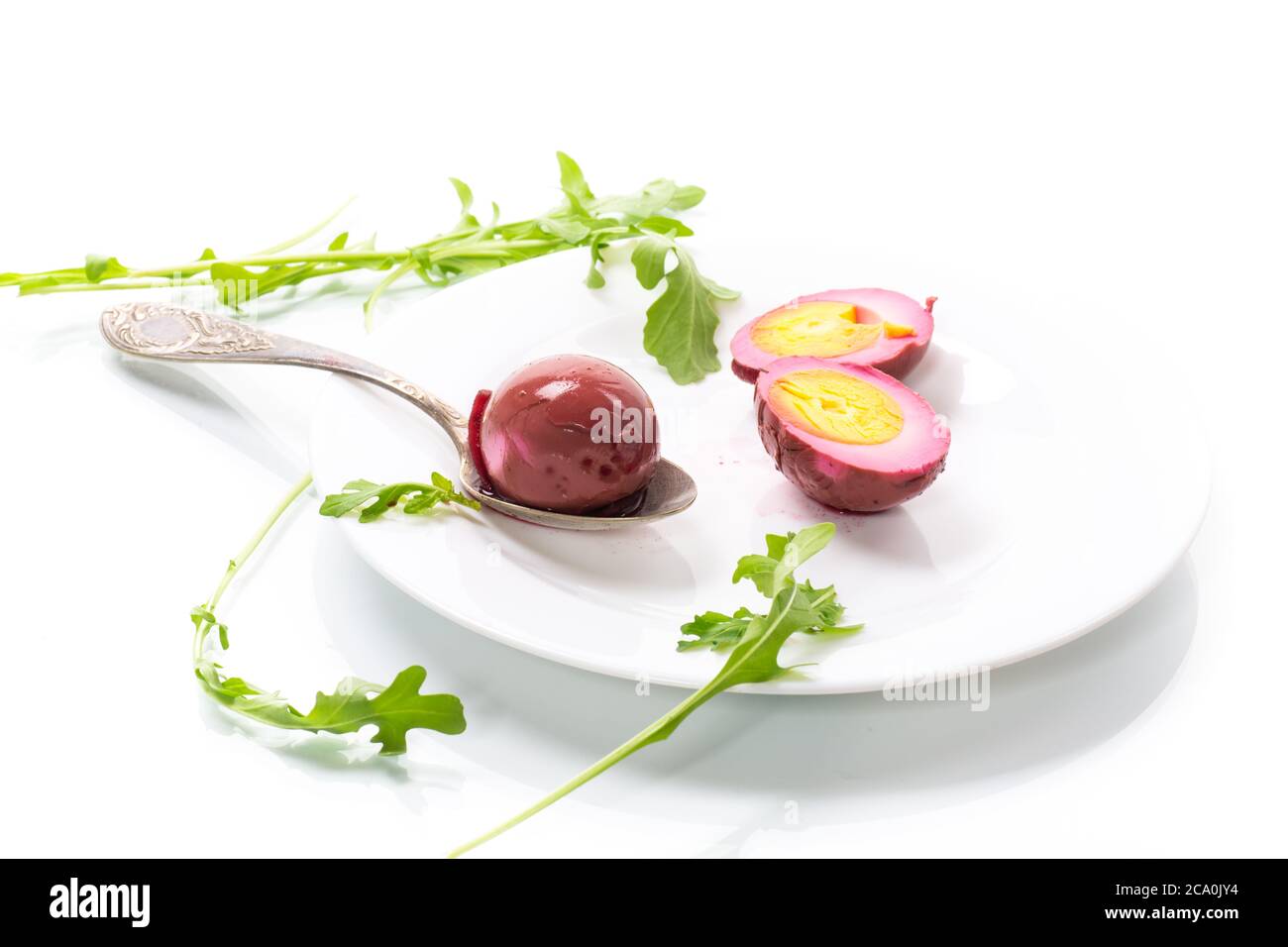 marinated chicken eggs in beetroot marinade in a plate isolated on ...