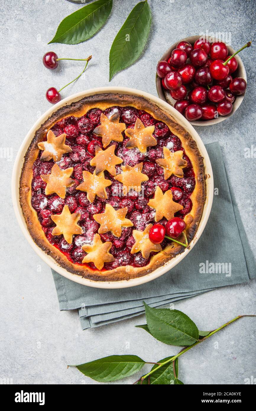 Homemade open cherry pie with frech cherries on a gray concrete background Stock Photo - Alamy