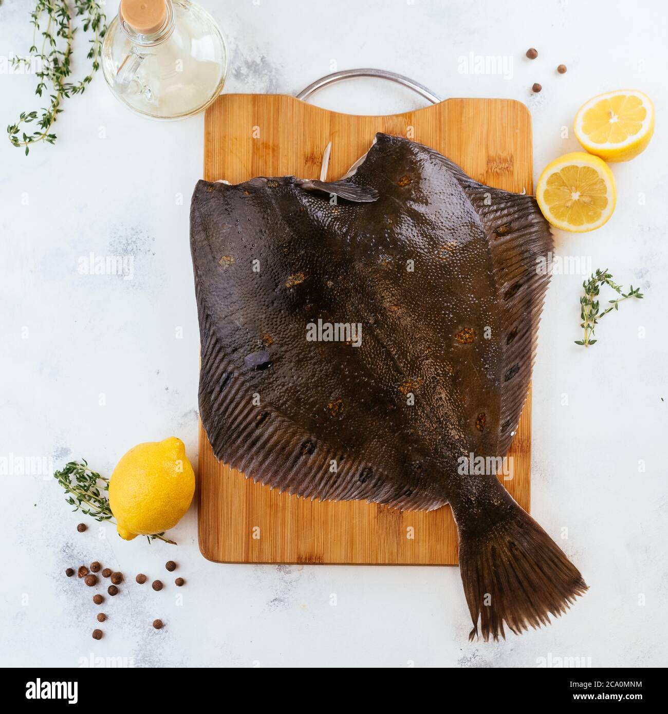 Raw flounder fish, layer on a wooden background Stock Photo - Alamy