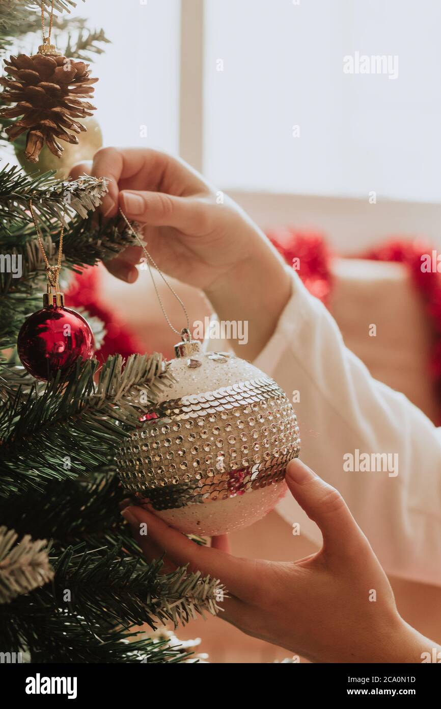 Unrecognizable person decorating christmas tree hi-res stock ...