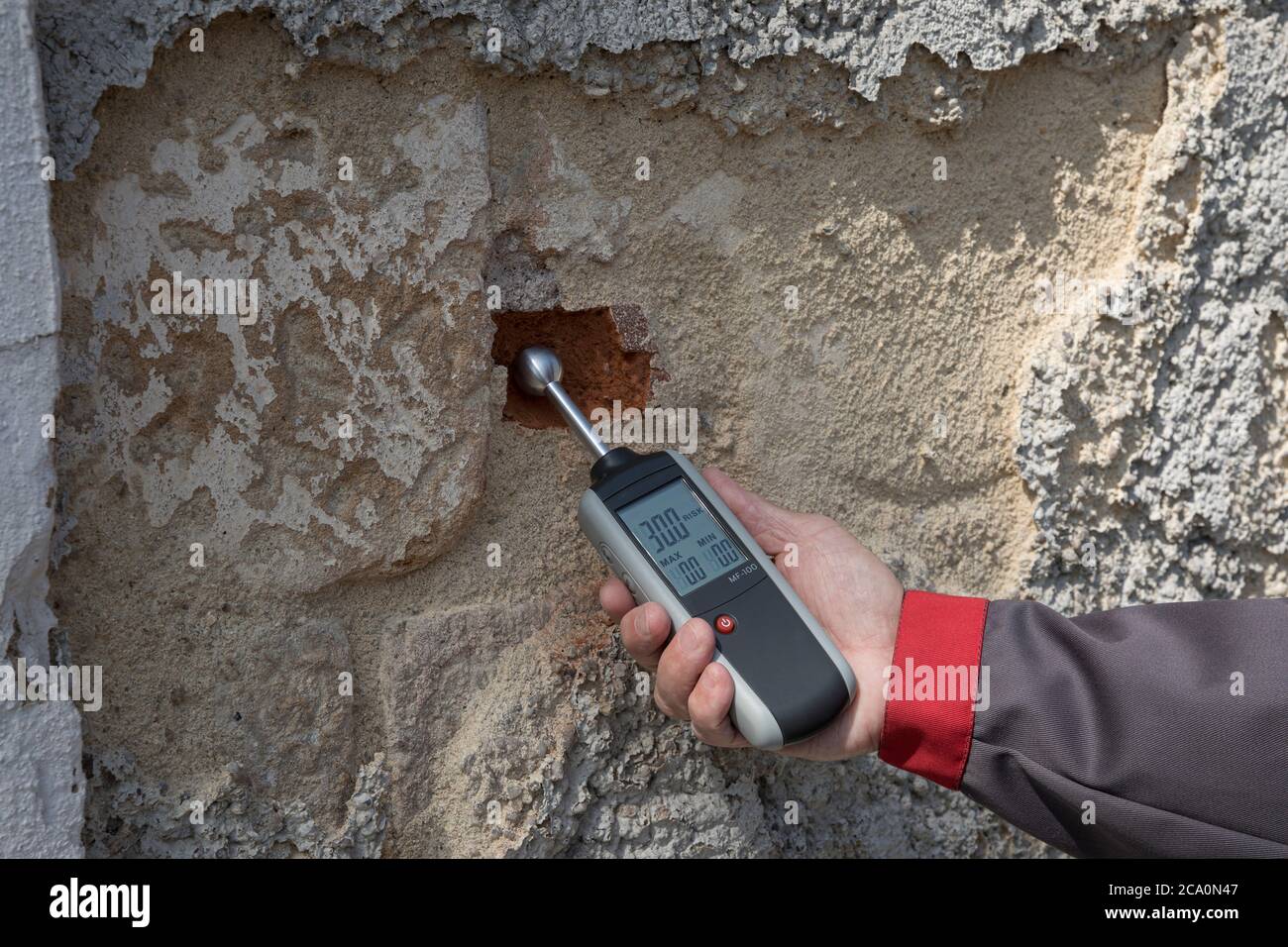 Measuring humidity with moisture indicator on a wall Stock Photo - Alamy