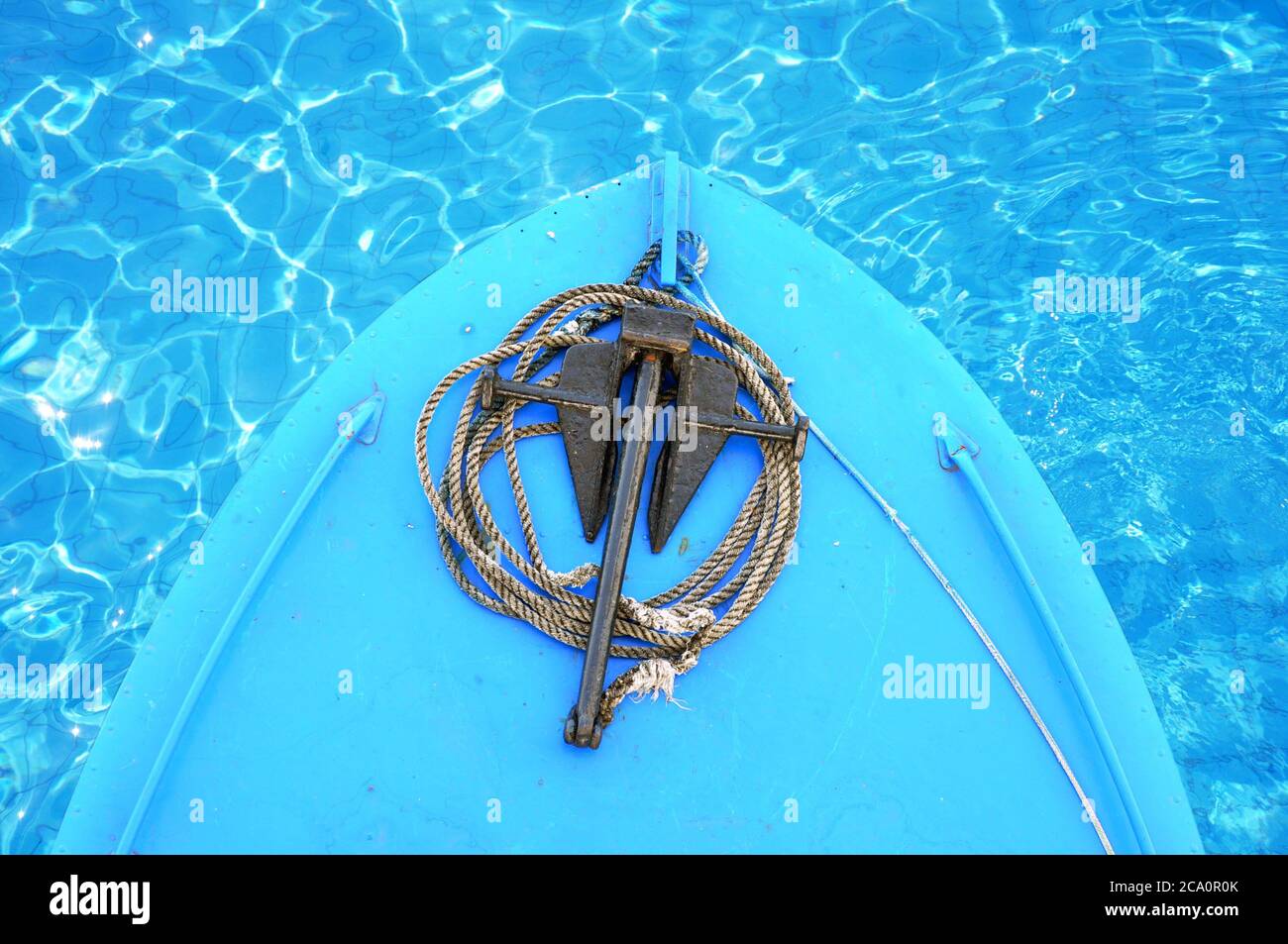 The bow of a boat floating on water with an anchor close-up Stock Photo ...