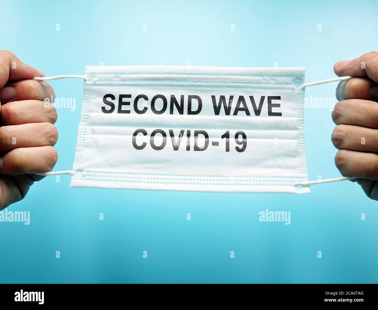 Second wave of covid-19. Hands hold medical mask Stock Photo - Alamy