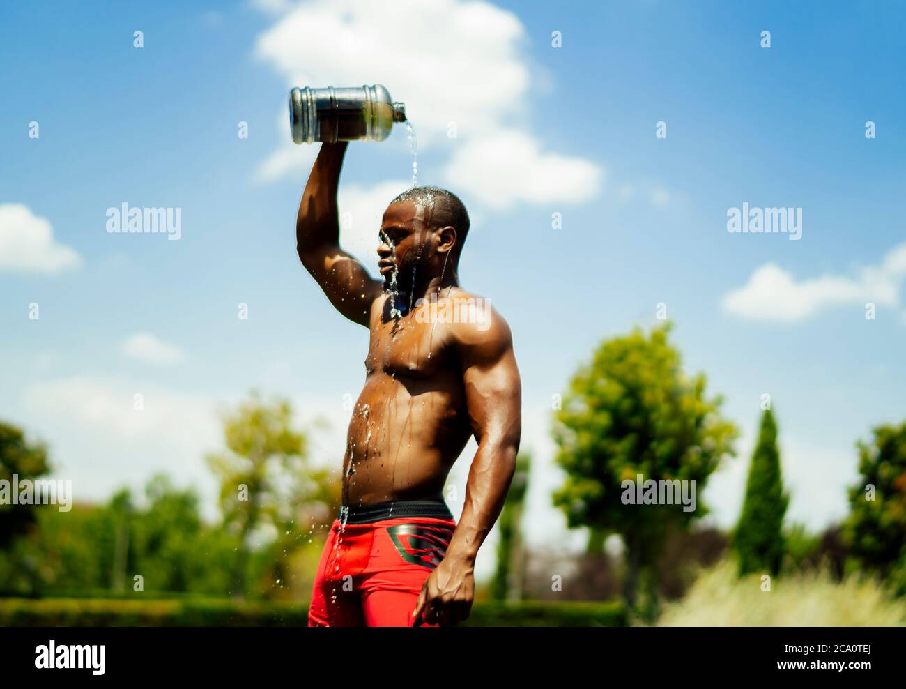 young athlete cooling off with water after doing sports Stock Photo - Alamy