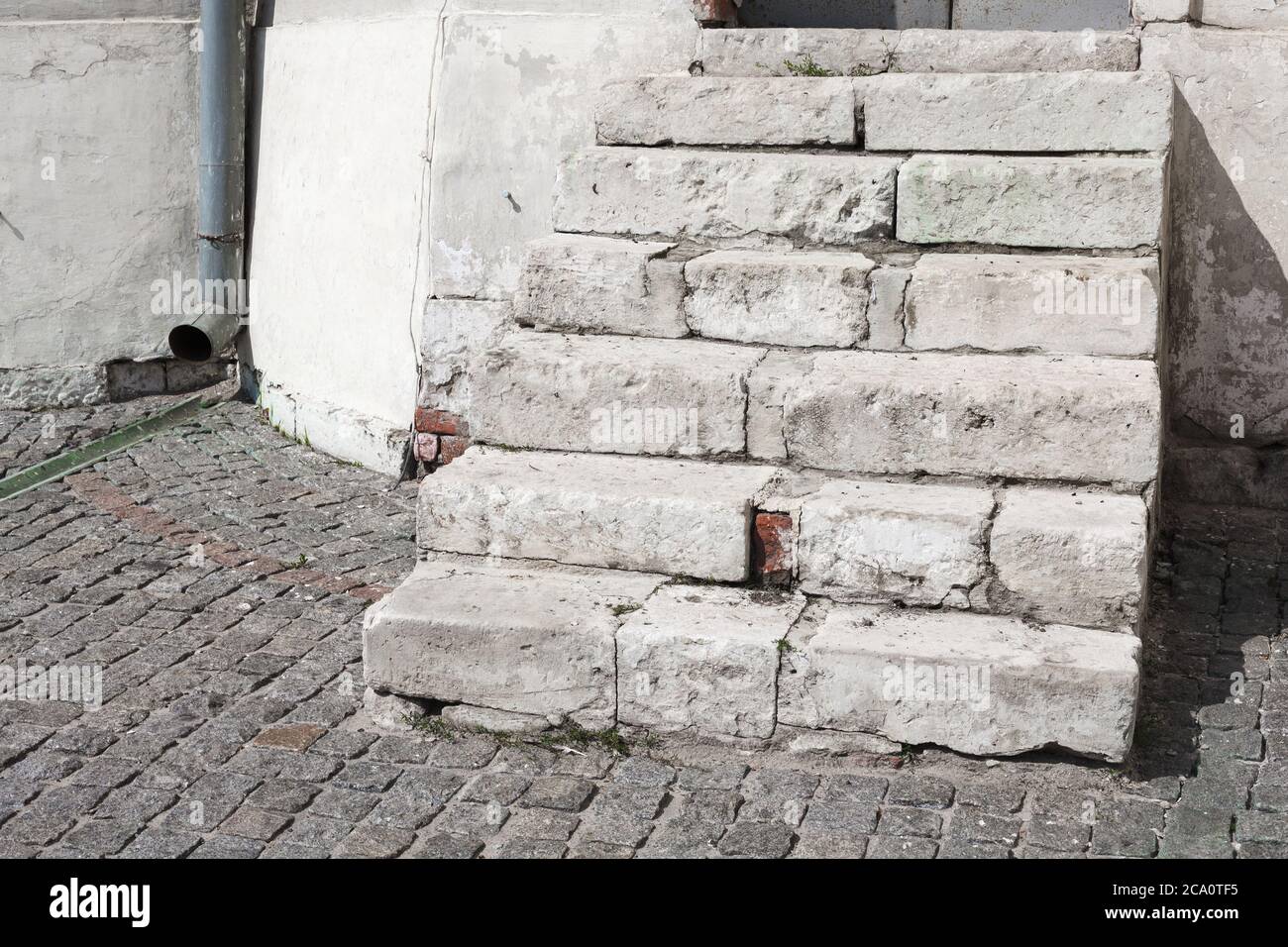 Ancient white stone steps on a cobblestone street Stock Photo - Alamy