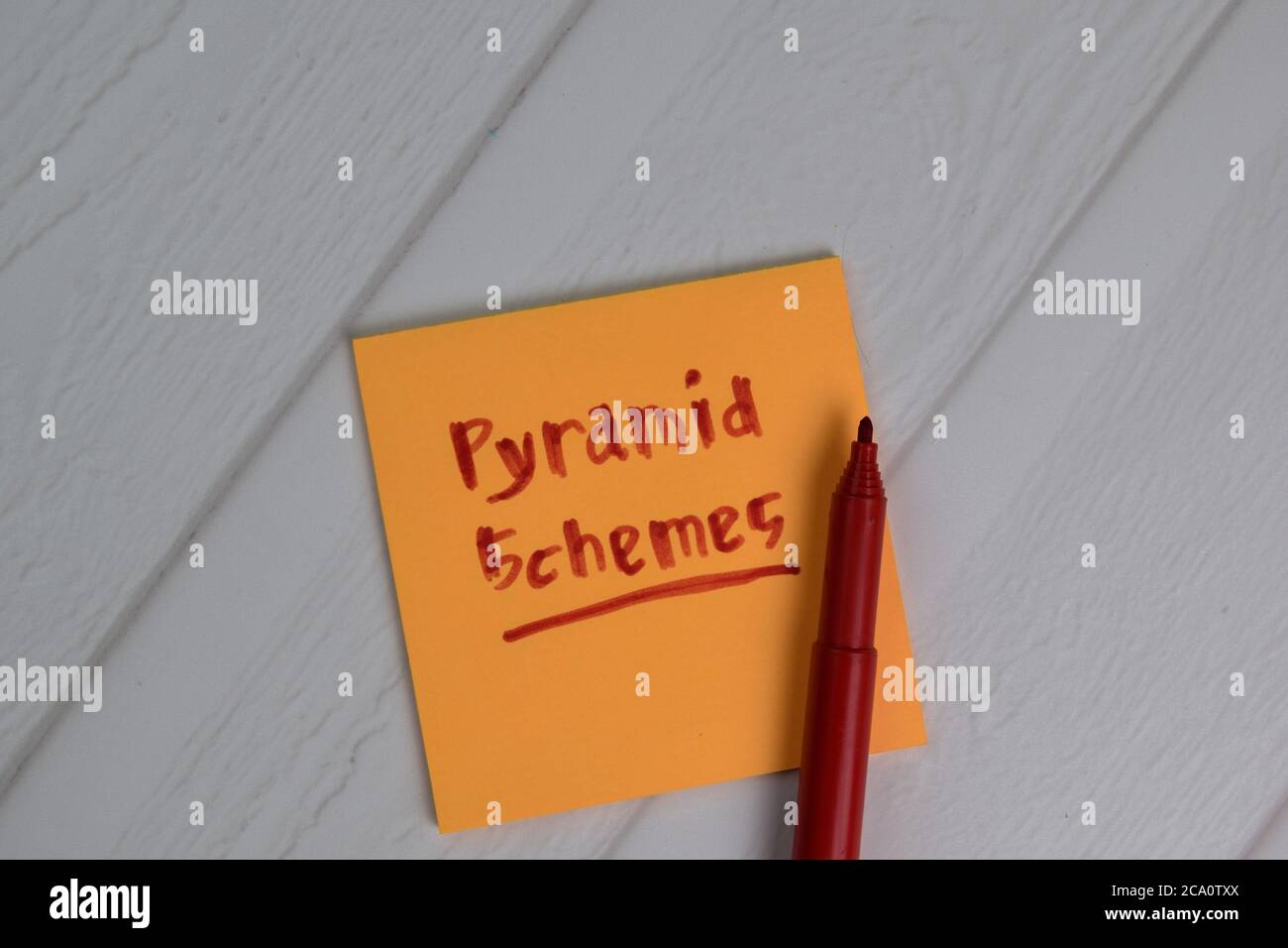 Pyramid Schemes write on sticky notes isolated on office desk Stock ...