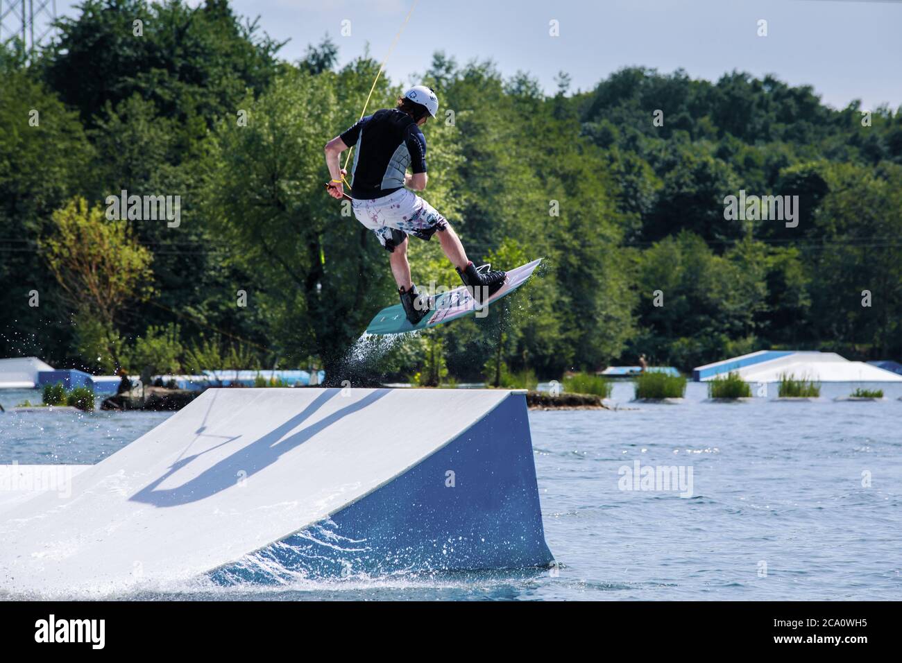 wakeboard jump with cable wakeboard at wake park while slide through ...