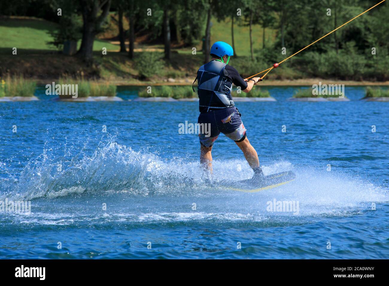 Wakeboard training with water splash and professional wakeboarder at a ...