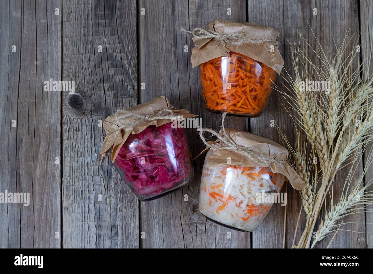 Fermented preserved vegetables on wooden rustic table top view with ...