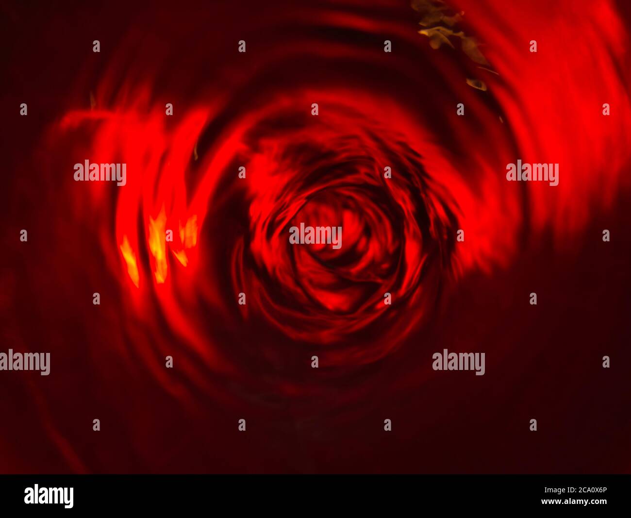 An artificially generated water cyclone in an illuminated glass ...