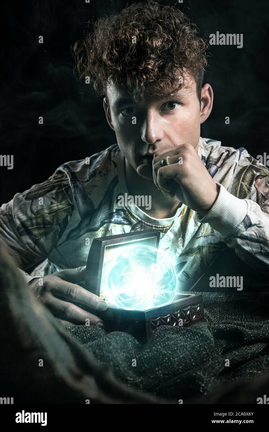 magic casket - man opens a mystical box with light coming out Stock ...