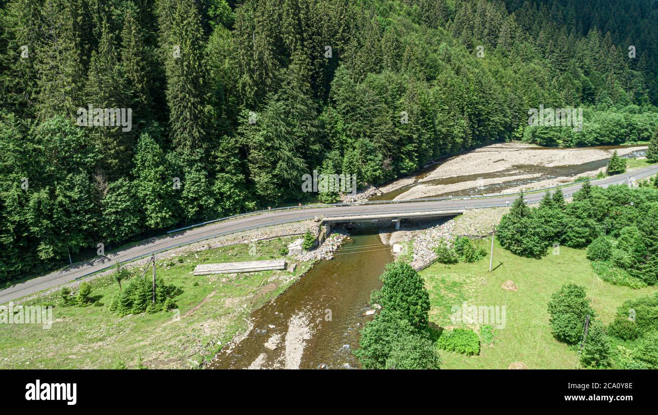 Automobile bridge over the river on the background of the forest in the ...