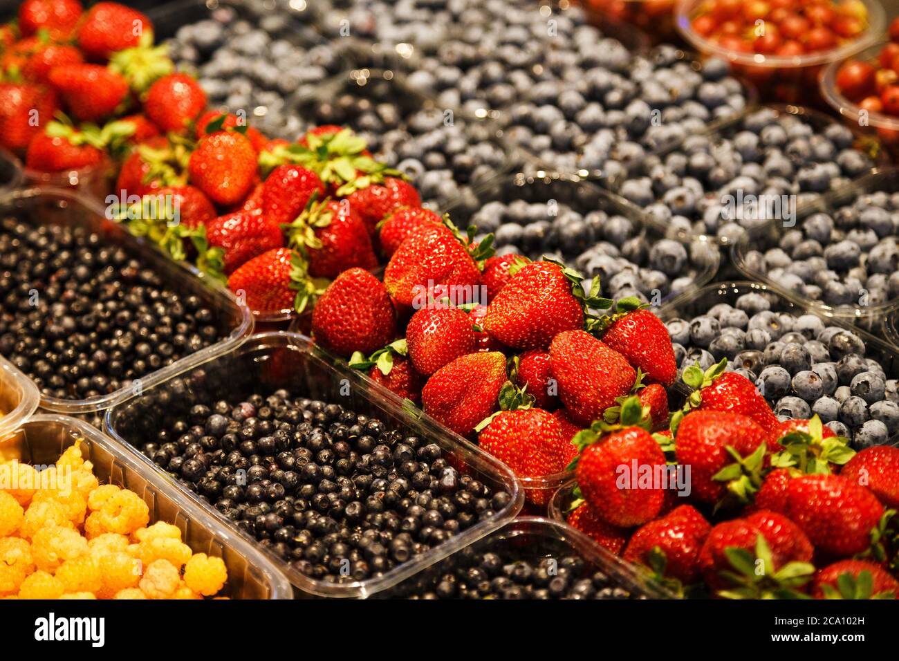 Colourful mix of different fresh berries at market Stock Photo - Alamy