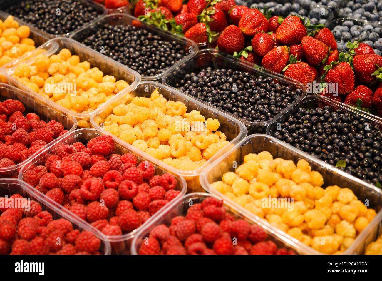 Colourful mix of different fresh berries at market Stock Photo - Alamy