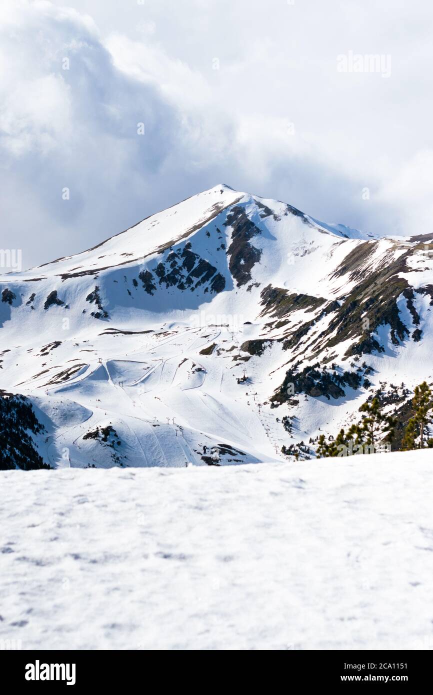 Impressive snowy peaks behind the snow covered hill Stock Photo - Alamy