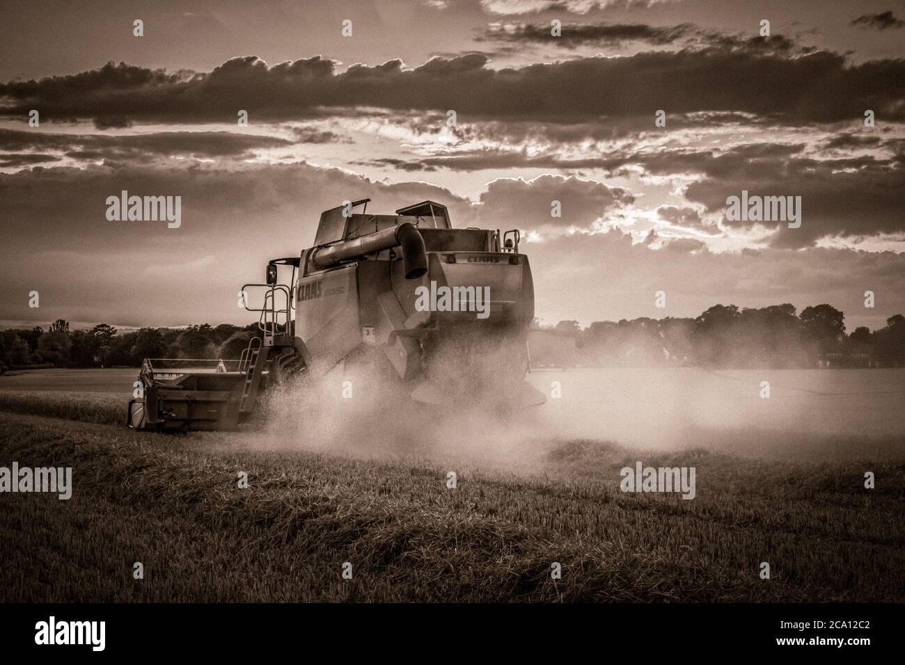 Black and white Combine Harvester at Sunset Stock Photo - Alamy