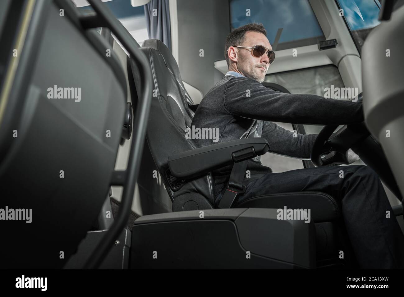 Caucasian Male Coach Bus Driver in His 40s Behind Vehicle Steering ...