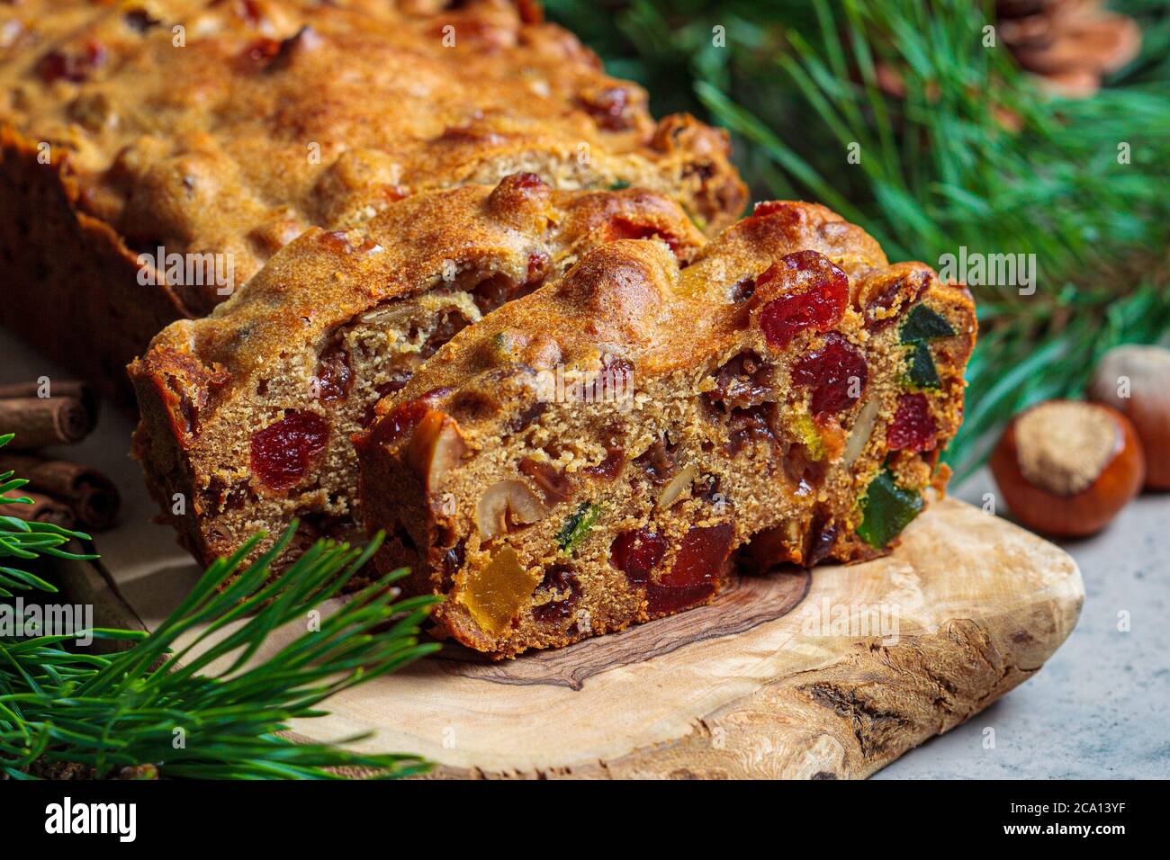 Traditional Christmas fruit cake on a wooden board in a festive ...