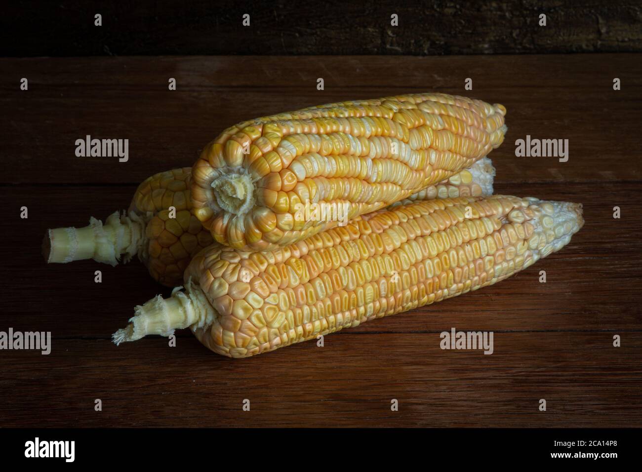 Corn cob on dark wooden rustic background. Detail texture Stock Photo ...