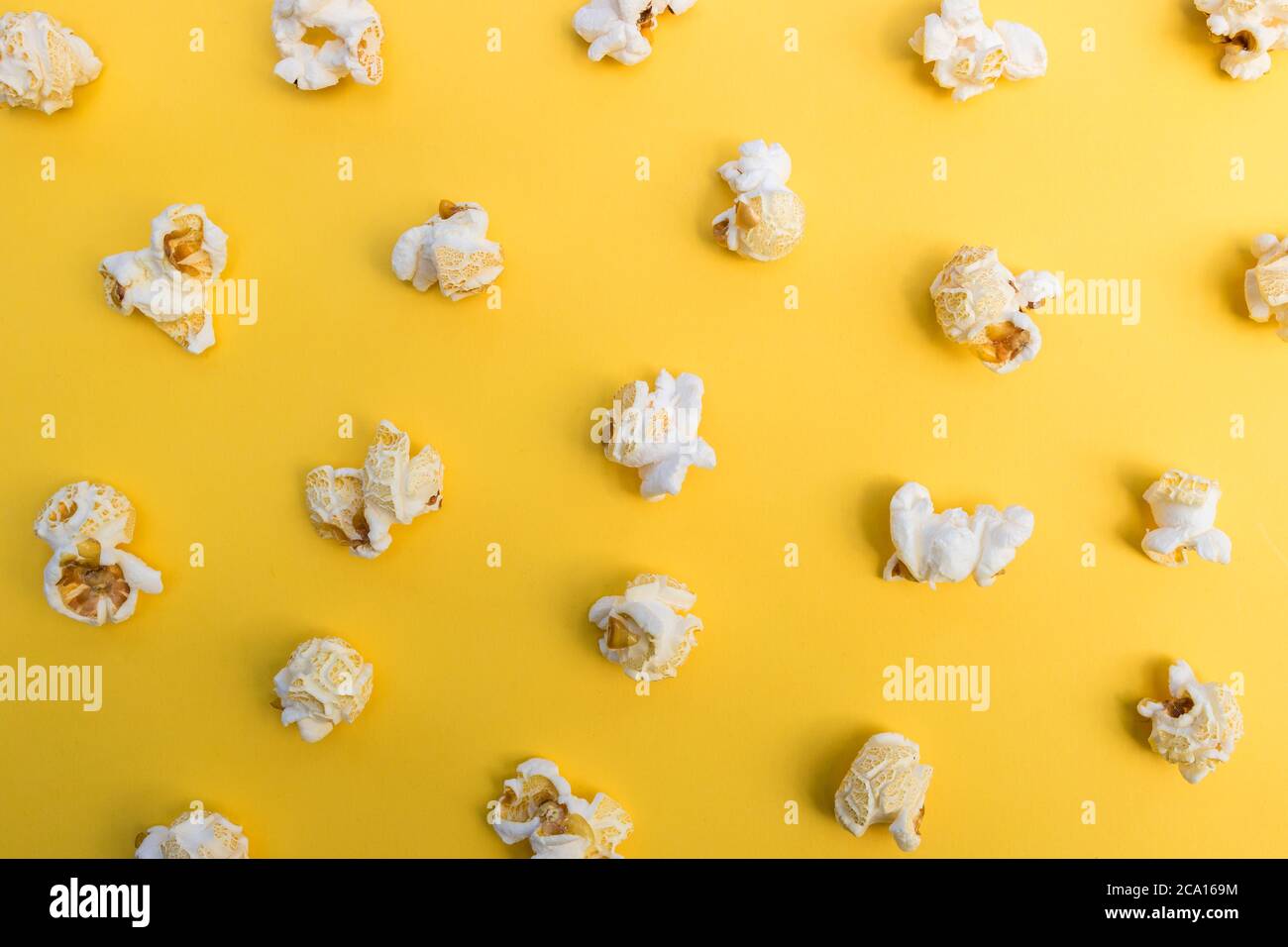 Popcorn on yellow color background minimal food Stock Photo - Alamy