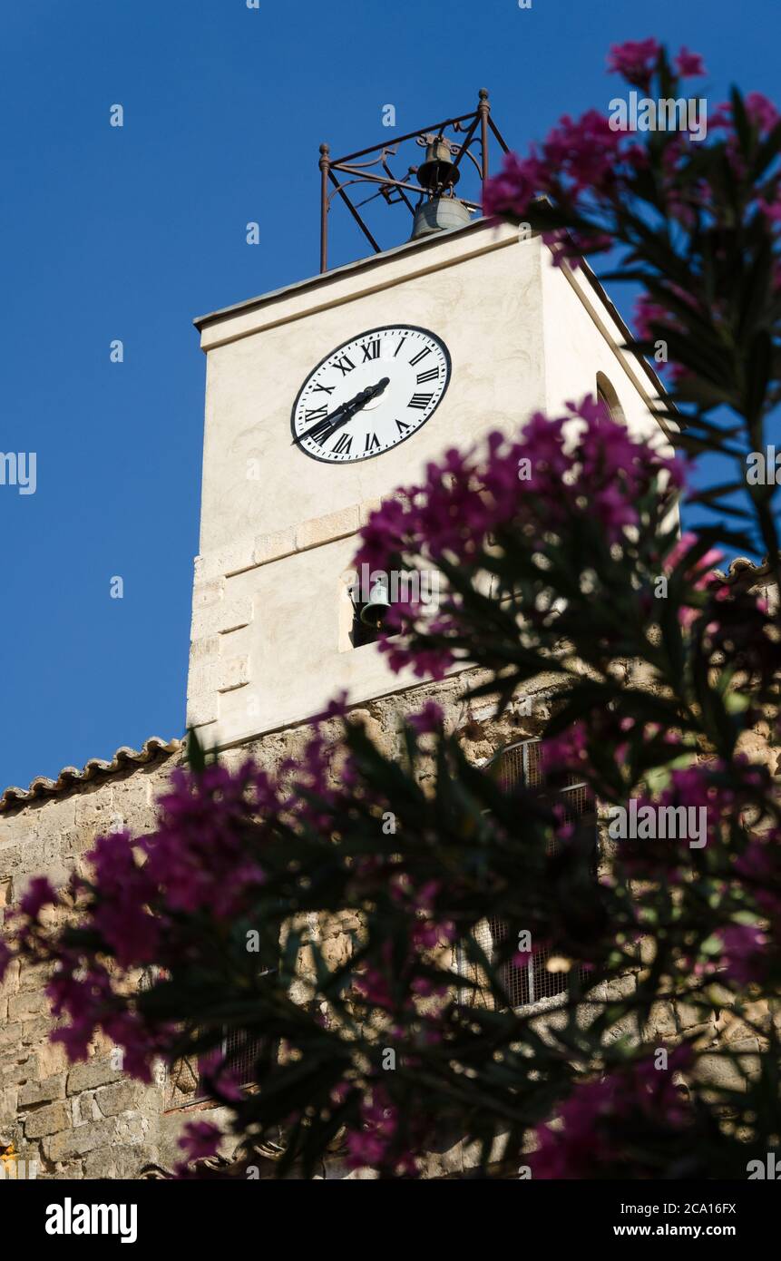The belfry of the church with a flowering tree in the foreground in the ...