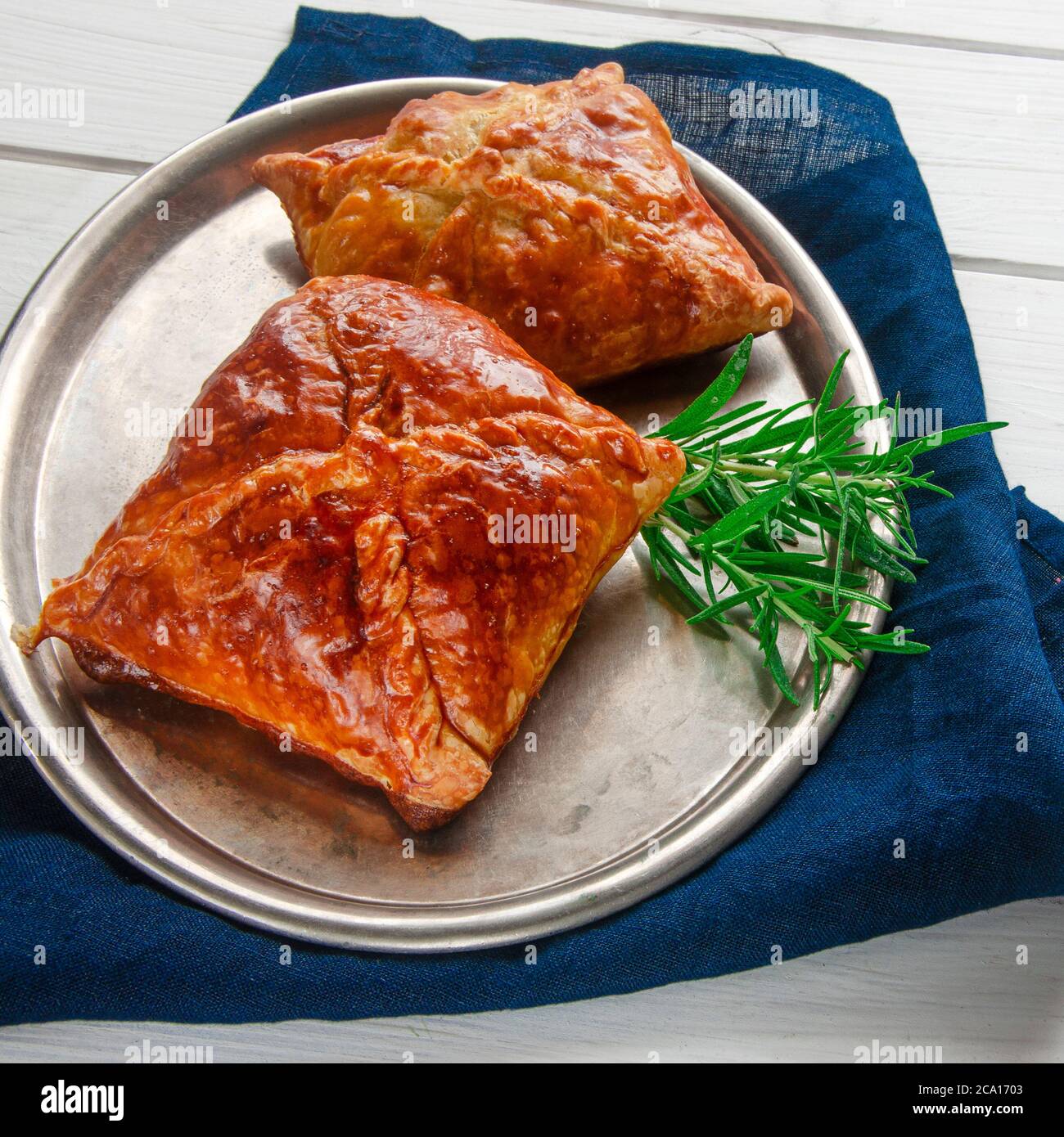 Homemade pastries with meat and spicy sauce with rosemary served on a ...