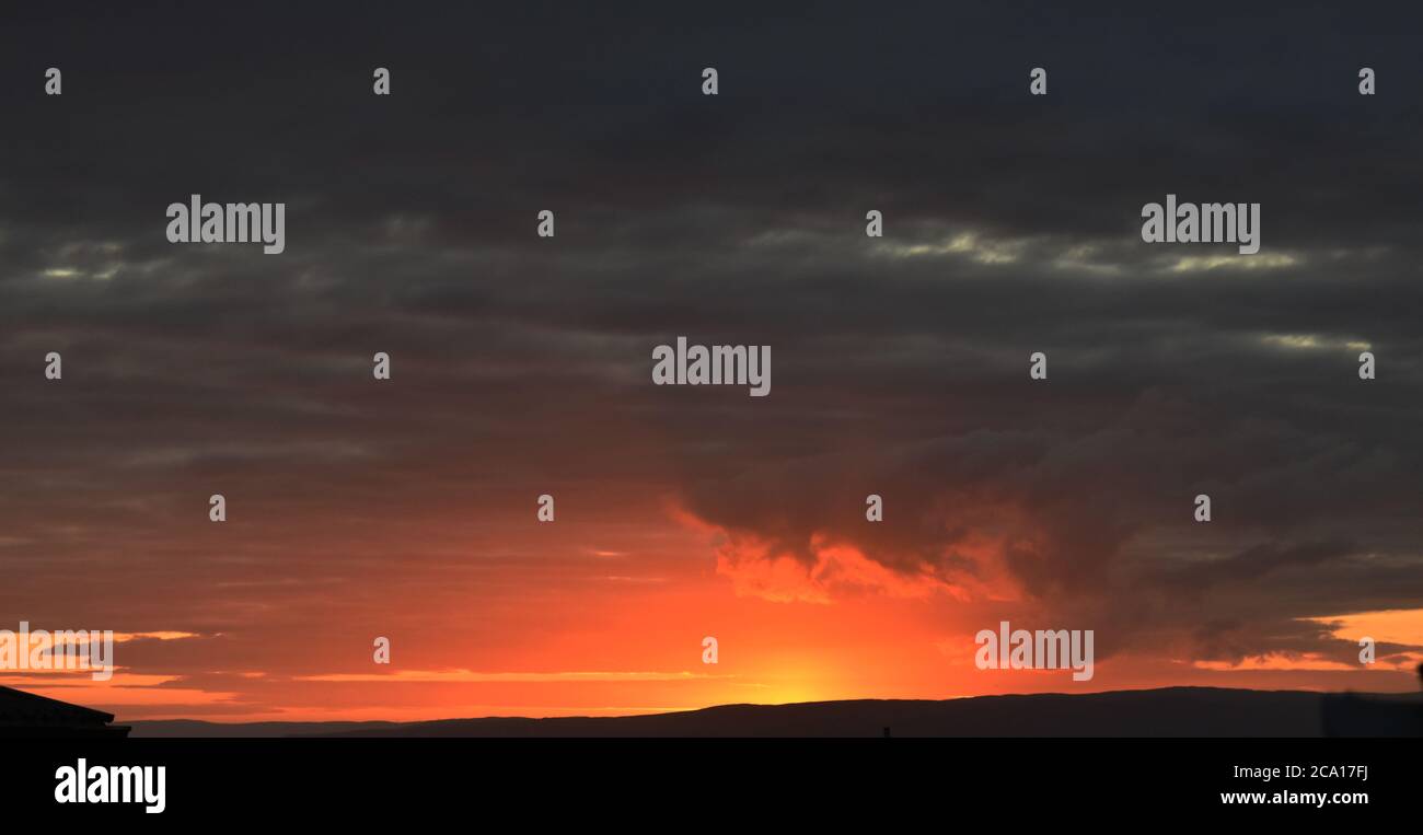 The sun is dipping below the horizon creating a beautiful sunset Stock ...