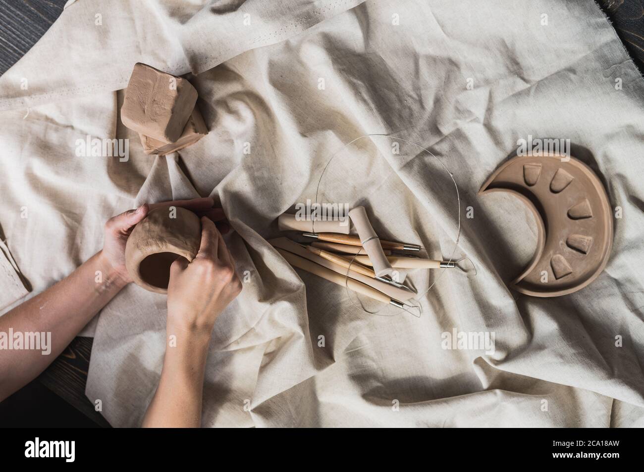 Table with materials and tools for pottery making craftsperson ...