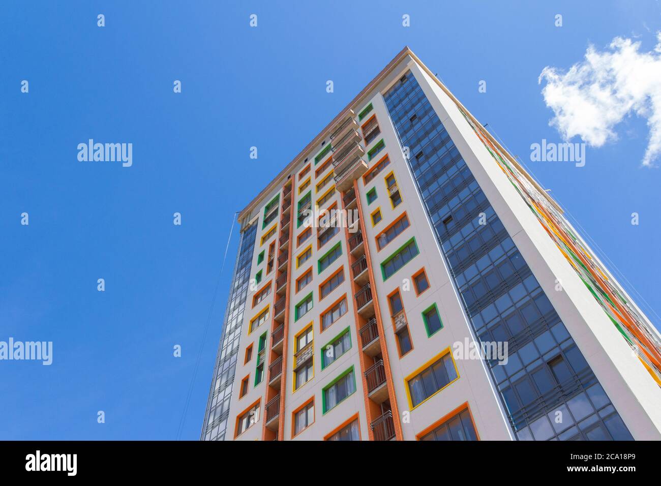 A high-rise building against a blue sky. A new high-rise residential ...